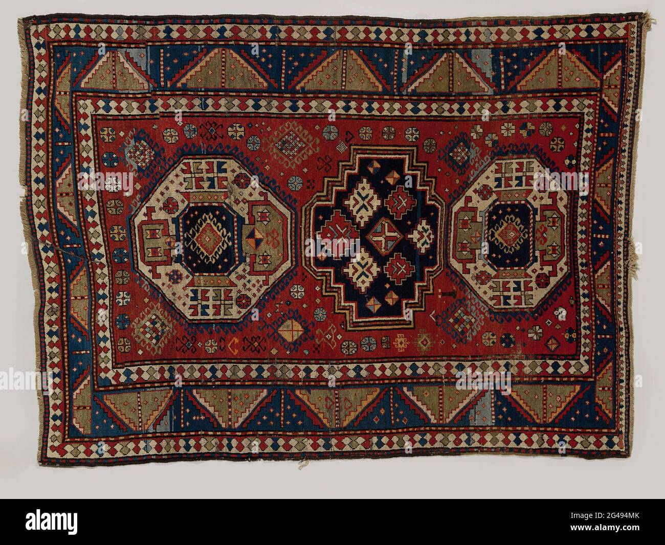 Carpet with three medallions filled with geometric figures on red ...