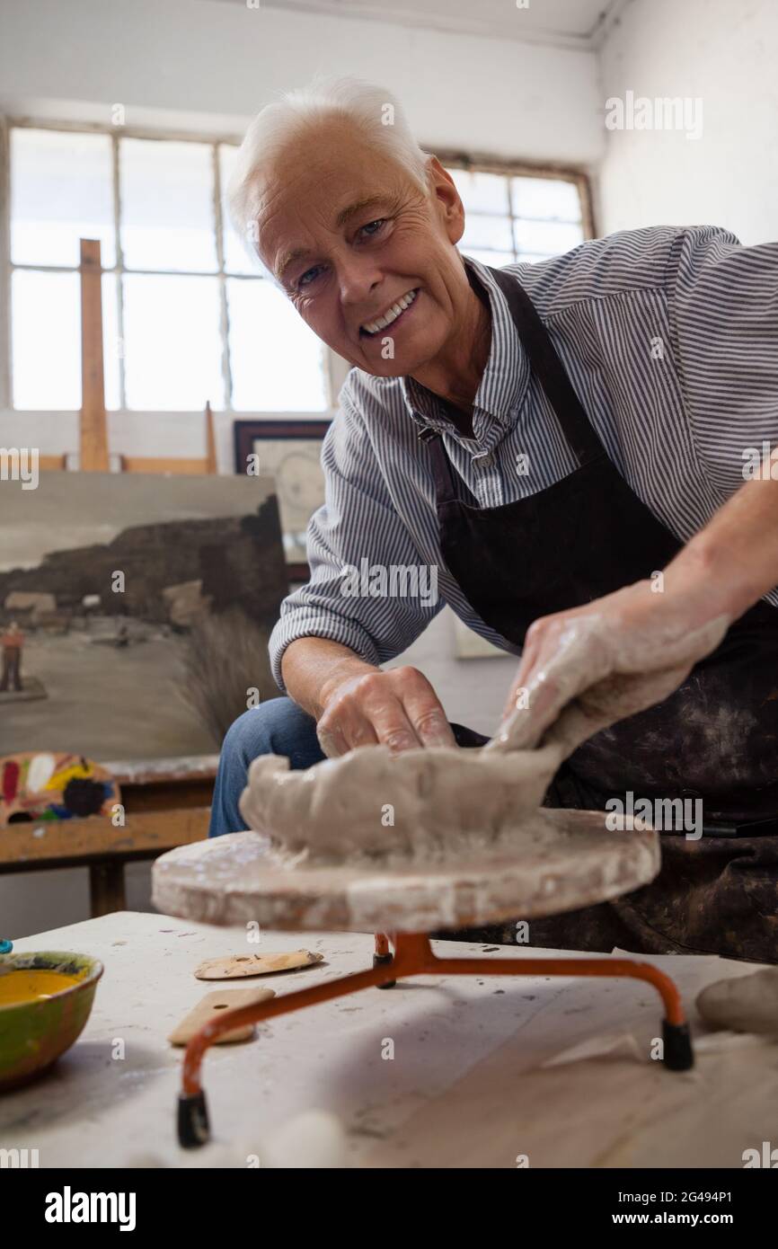 Portrait of senior man molding clay Stock Photo - Alamy
