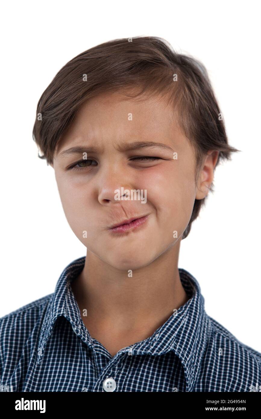 Cute boy standing against white background Stock Photo - Alamy