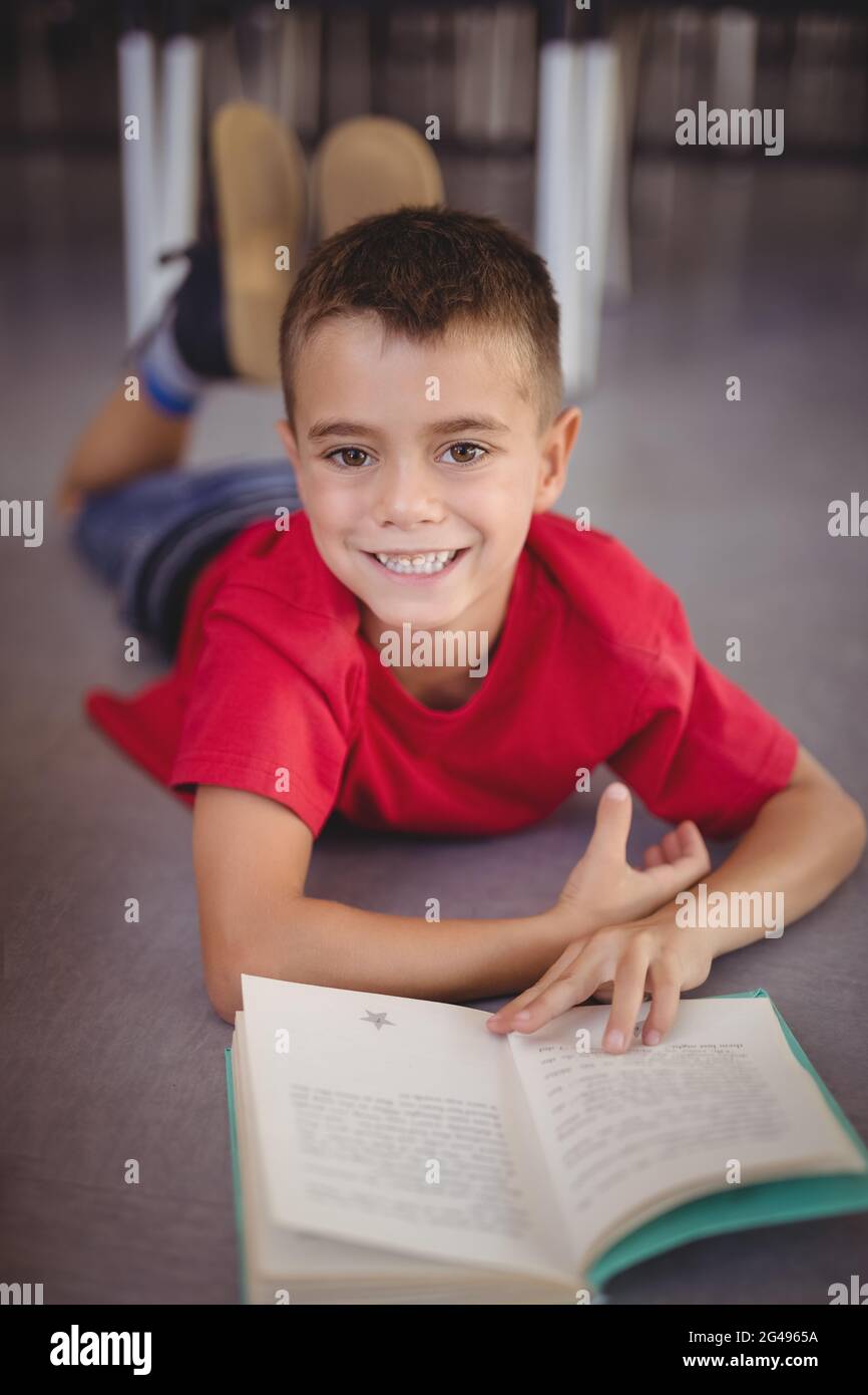 Boy lying in library reading hi-res stock photography and images - Alamy