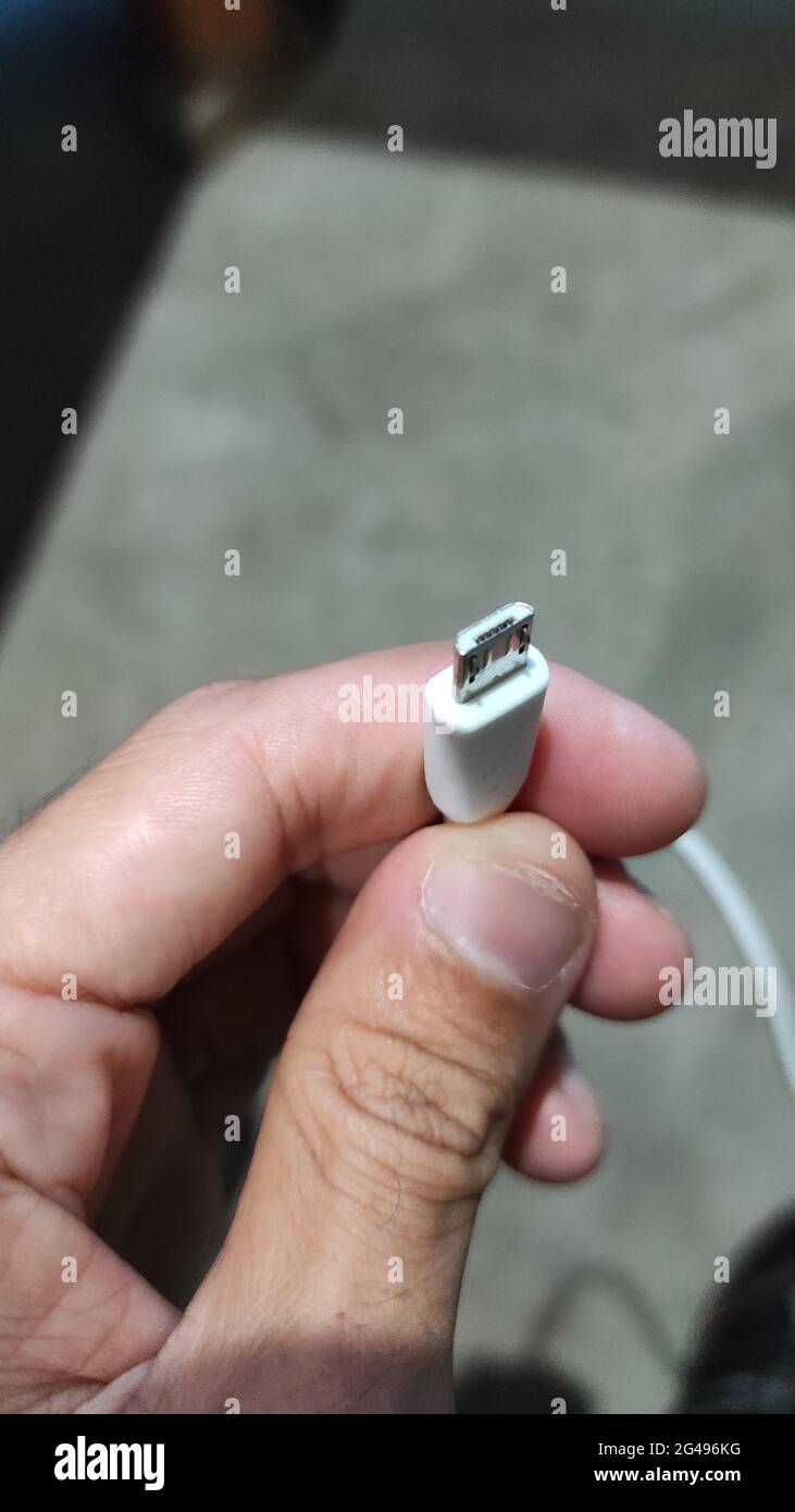 Hand holding charge plug hi-res stock photography and images - Alamy