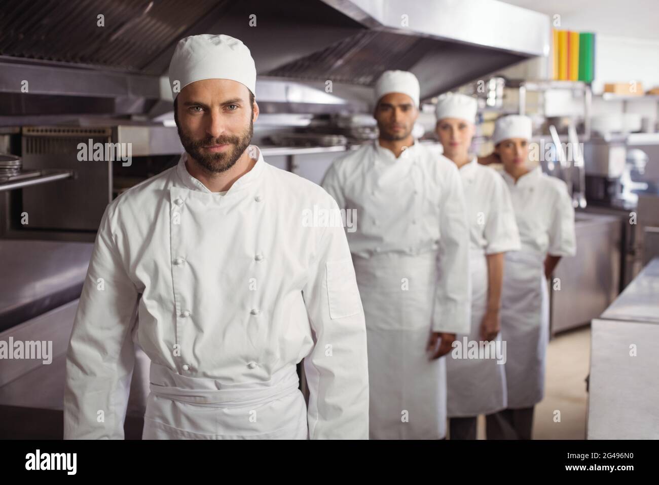 Happy chefs team standing together in commercial kitchen Stock Photo ...