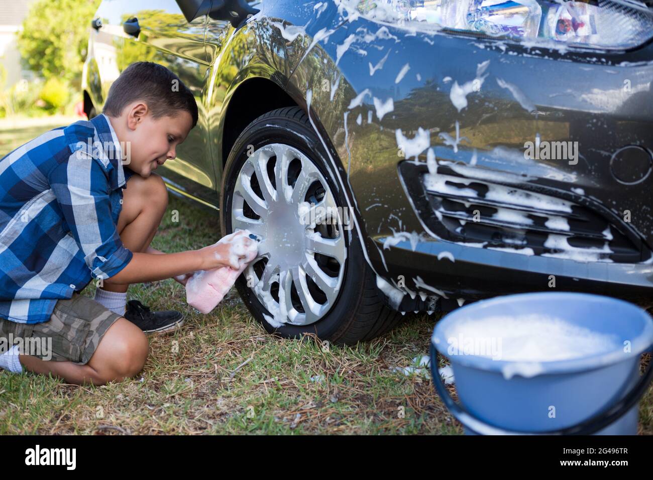 Teenage boy washing car hi-res stock photography and images - Alamy