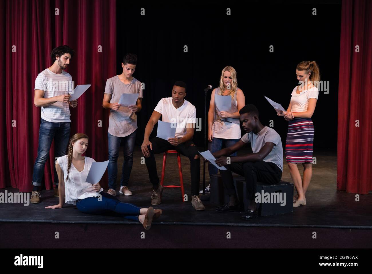 Actors reading their scripts on stage Stock Photo - Alamy