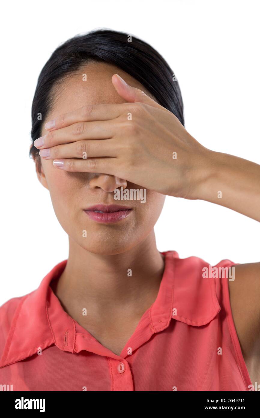 Woman covering her eyes with hand against white background Stock Photo ...