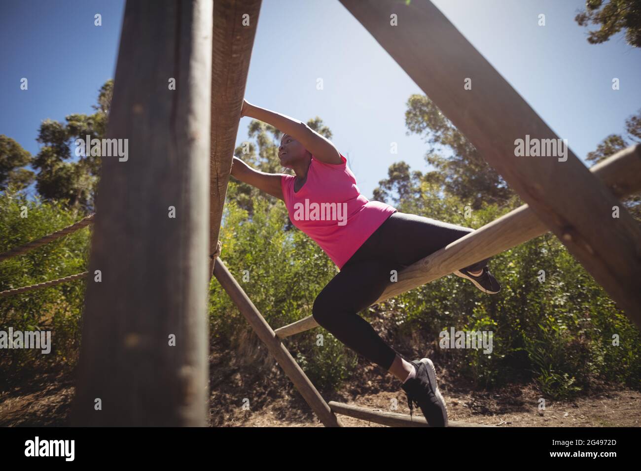 Young woman obstacle course climbing hi-res stock photography and ...