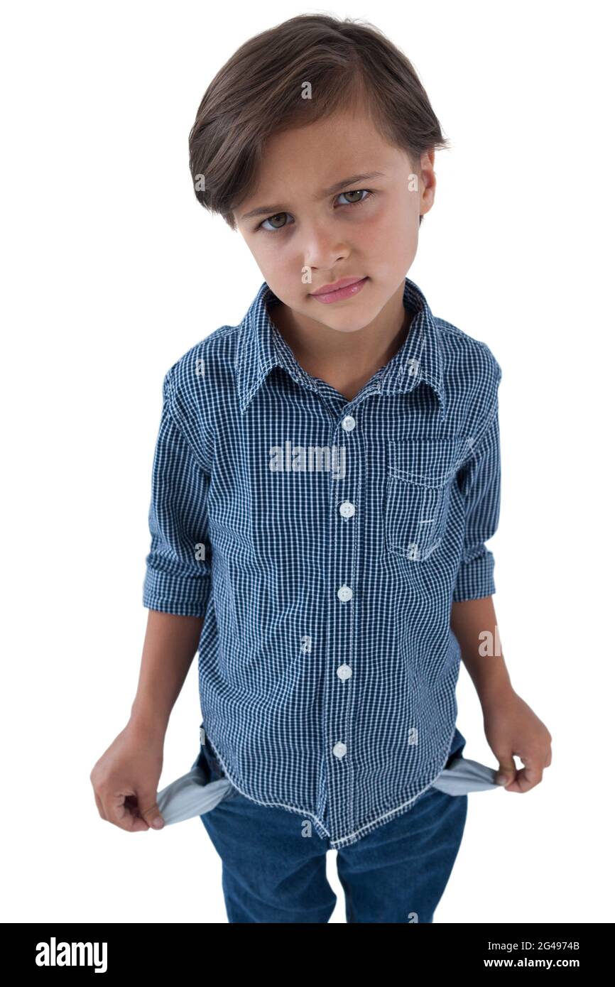 Boy standing with empty pockets against white background Stock Photo ...