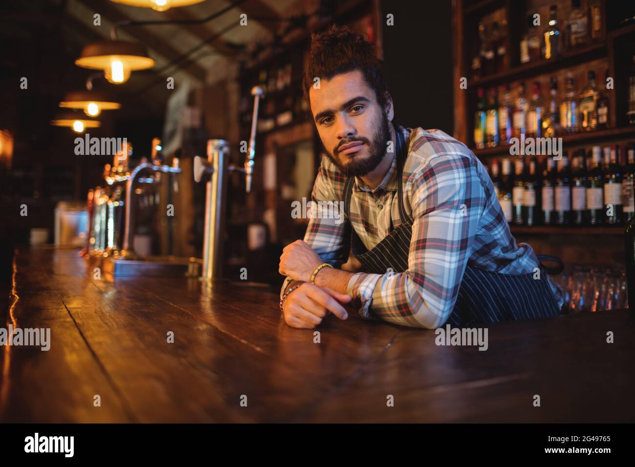 Portrait of waiter leaning at counterÃ‚Â Stock Photo - Alamy