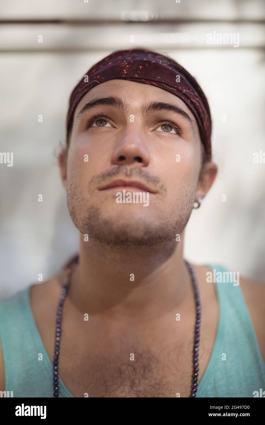 Thoughtful man looking up Stock Photo - Alamy