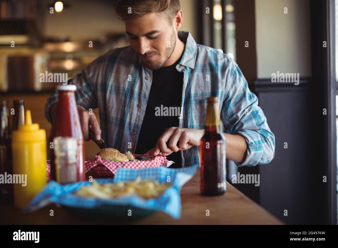 Man having burger together Stock Photo - Alamy