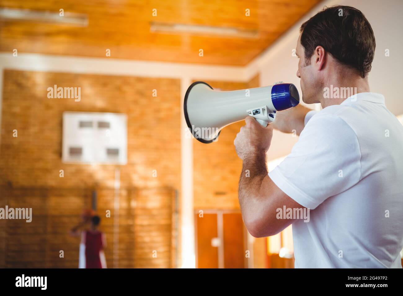 Male coach using megaphone Stock Photo - Alamy