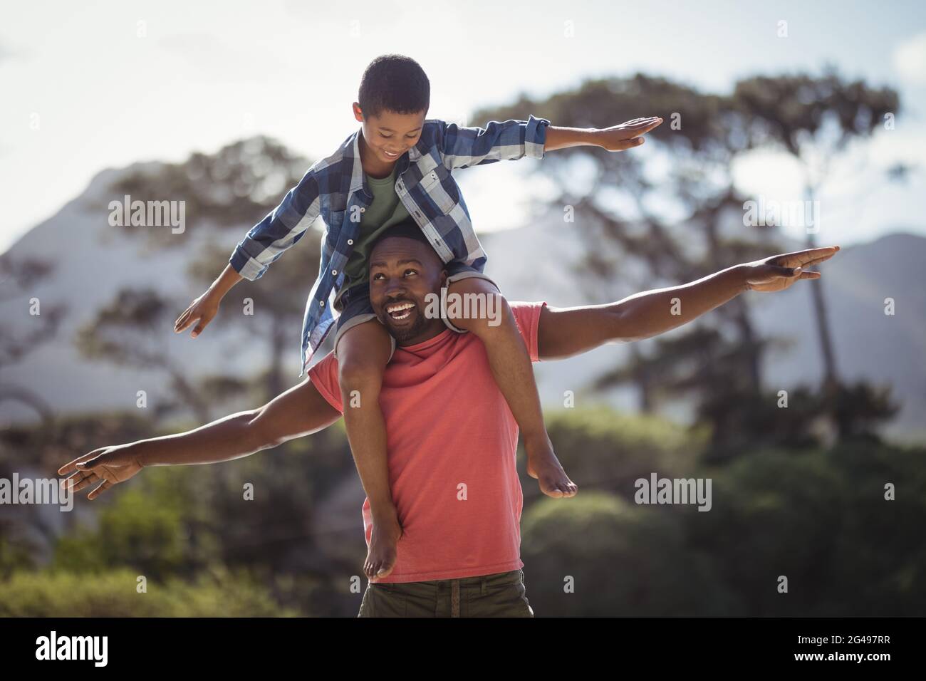 Father carrying son on shoulders Stock Photo - Alamy