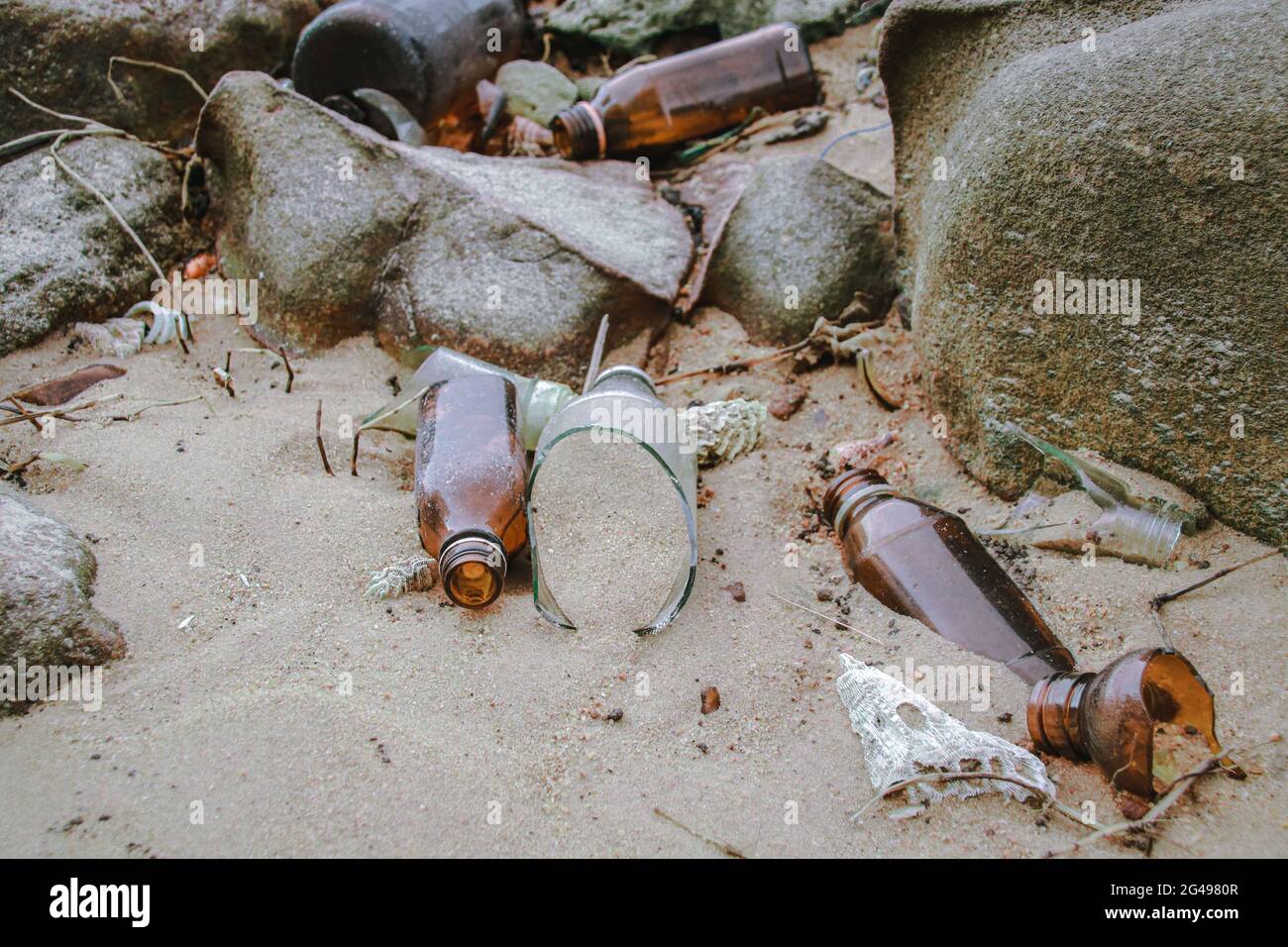 A polluted sandy beach with plastic bottles and other garbage Stock ...