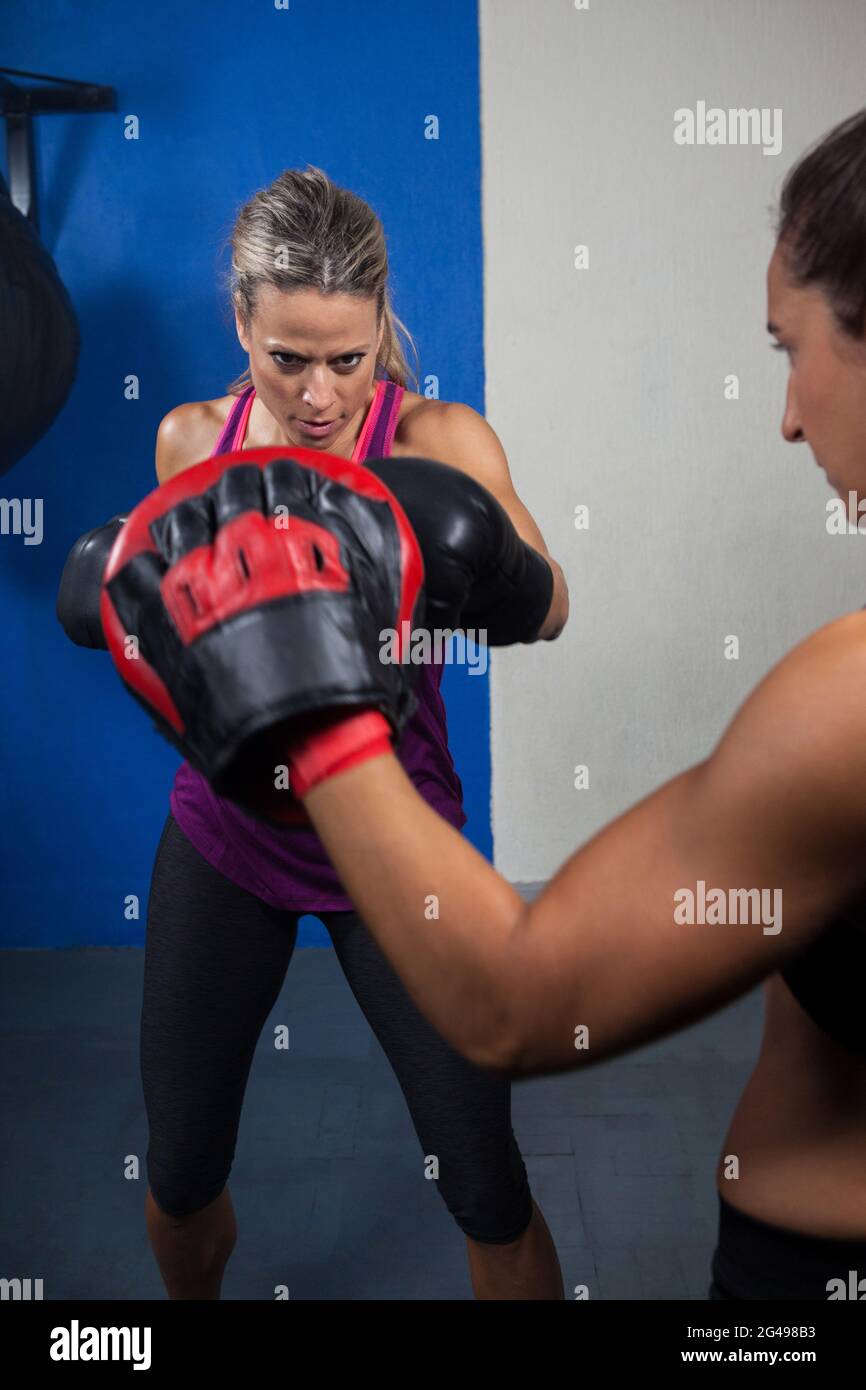 Determined woman boxing gloves punching hi-res stock photography and ...