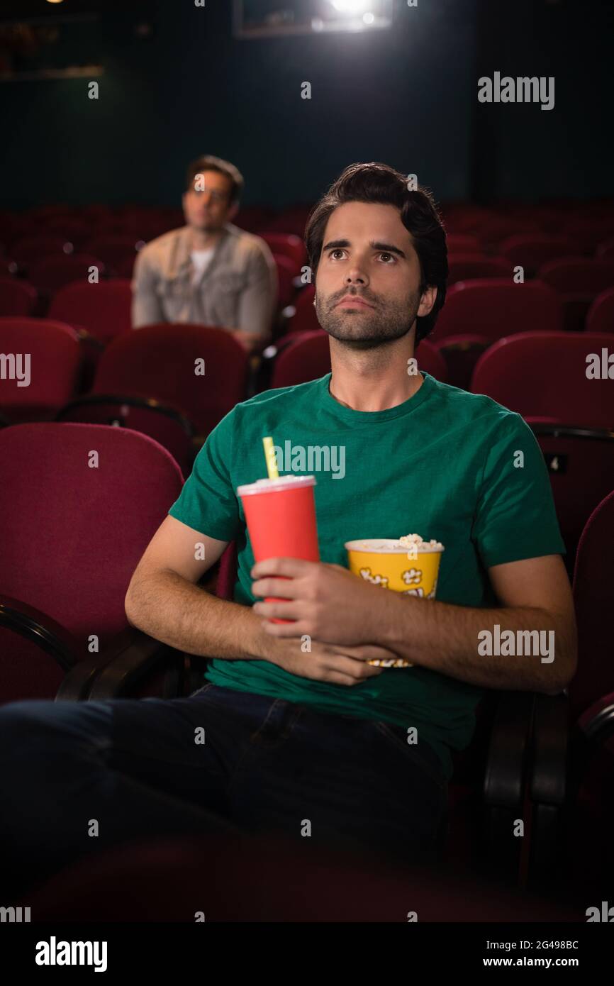 Man watching movie in theatre Stock Photo - Alamy