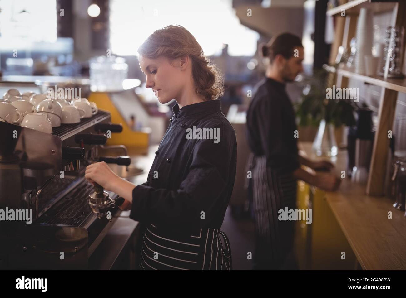 Side view of young baristas Stock Photo - Alamy