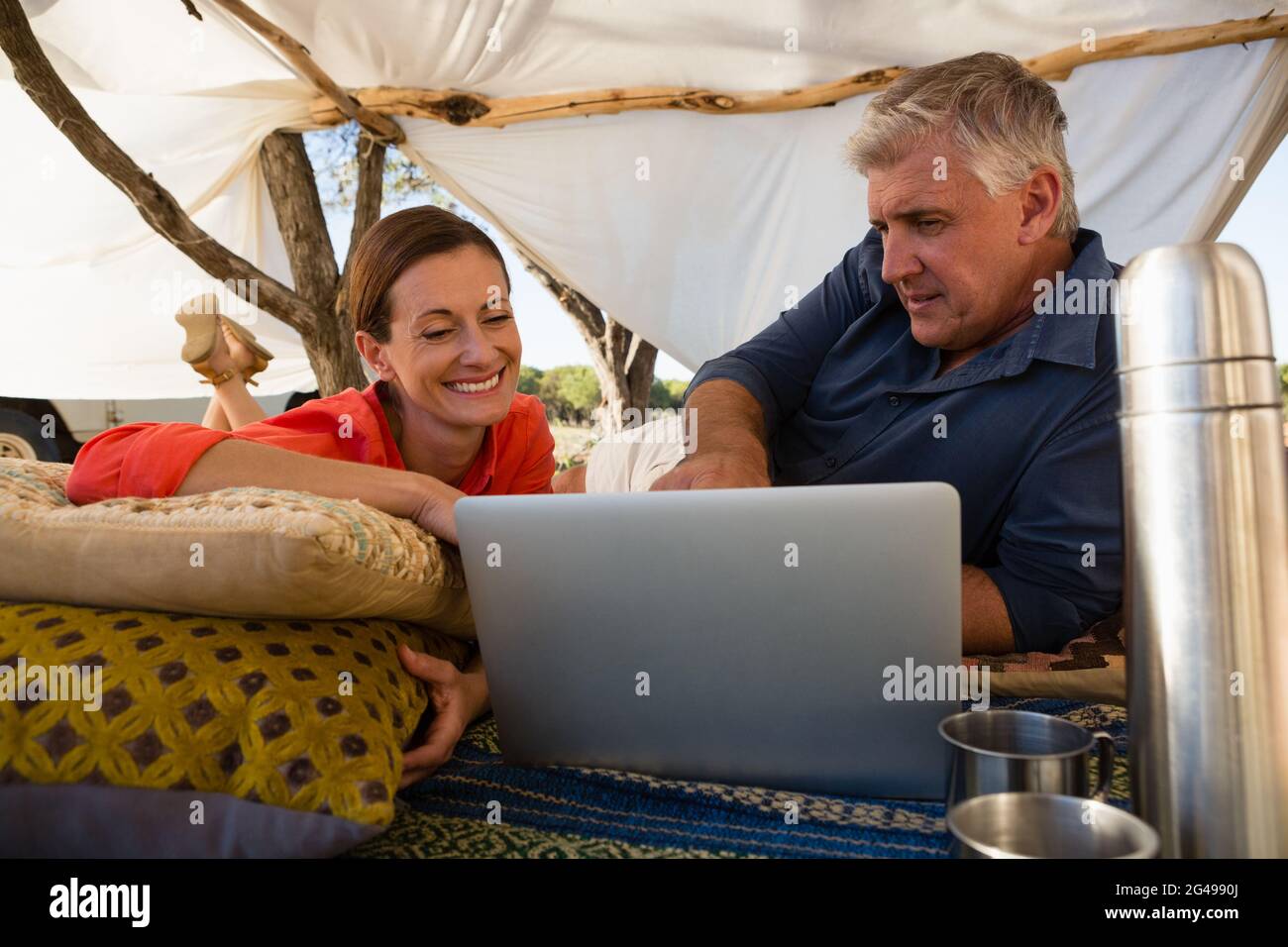Couple looking at laptop in tent Stock Photo - Alamy