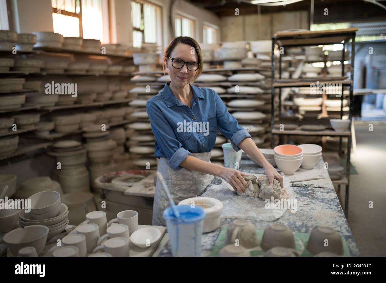 Portrait of female potter molding a clay Stock Photo - Alamy