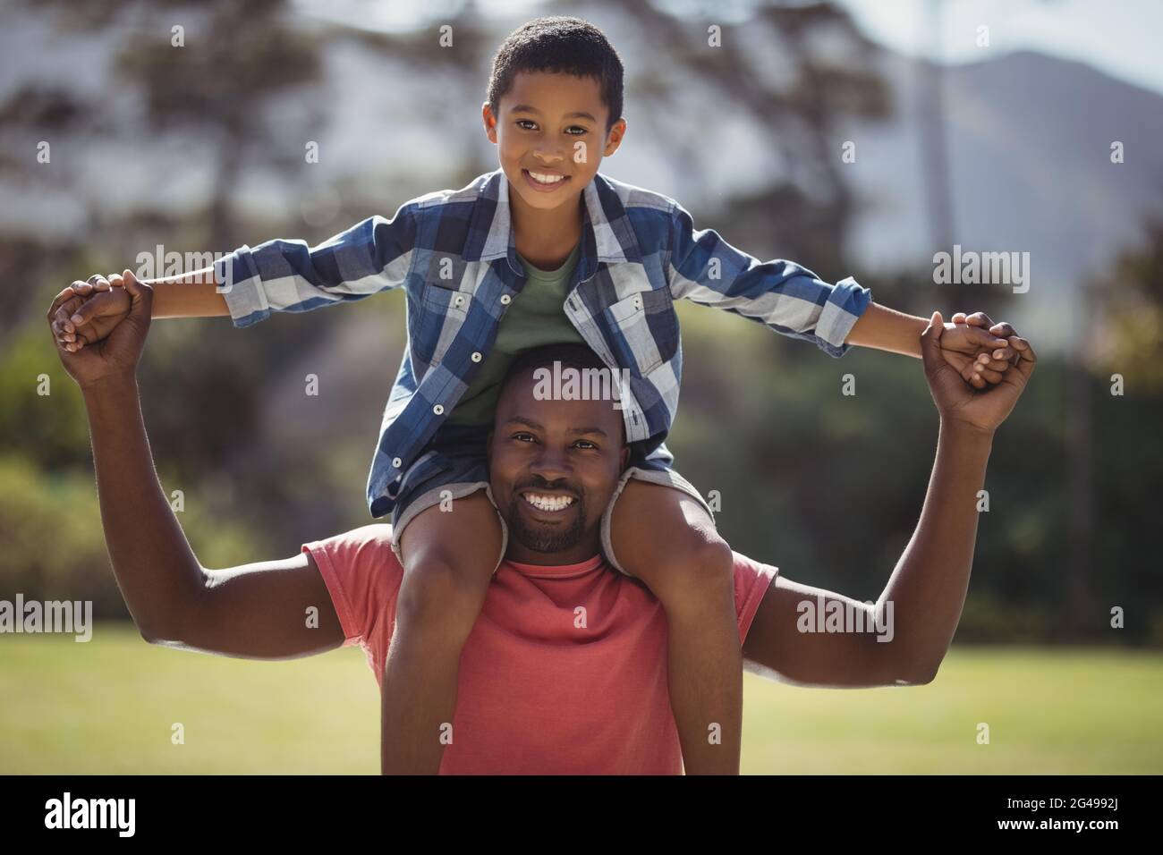 Happy father carrying son on shoulders Stock Photo - Alamy