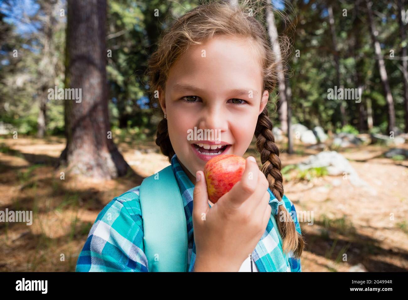 Girl having apple in the forest Stock Photo - Alamy