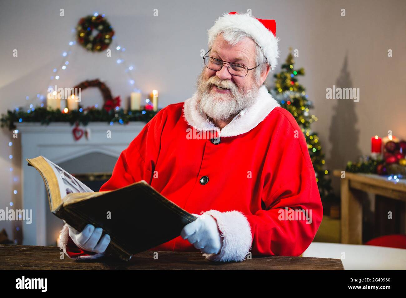 Santa Claus reading book Stock Photo - Alamy
