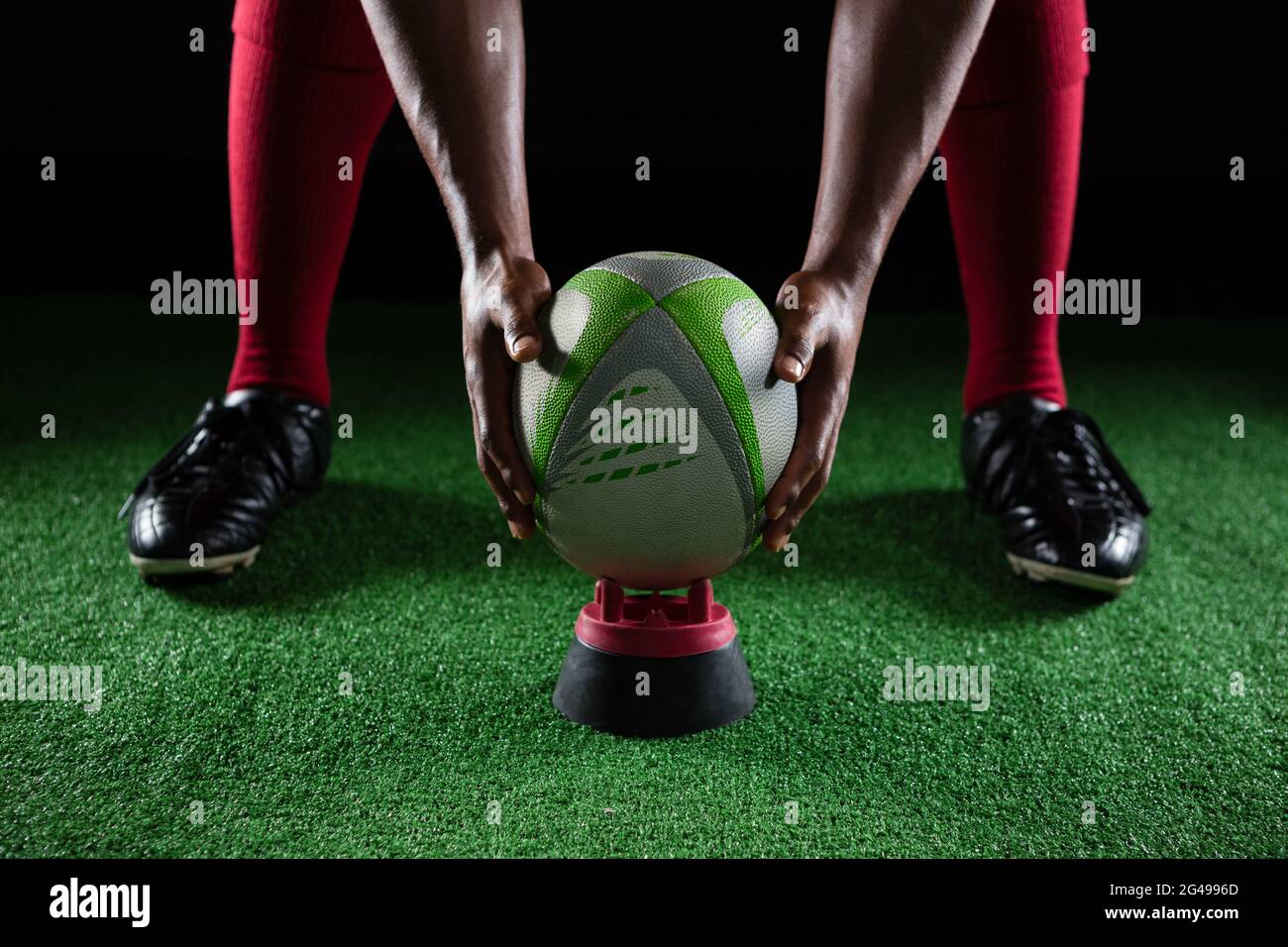 Low section sportsman keeping ball on tee Stock Photo - Alamy