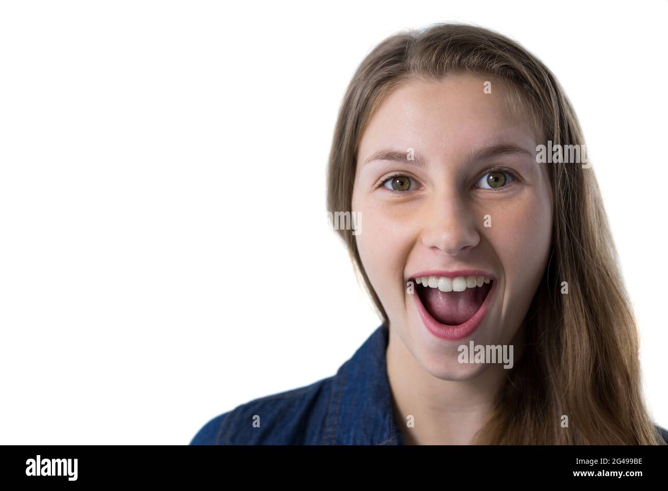 Excited teenage girl standing against white background Stock Photo - Alamy