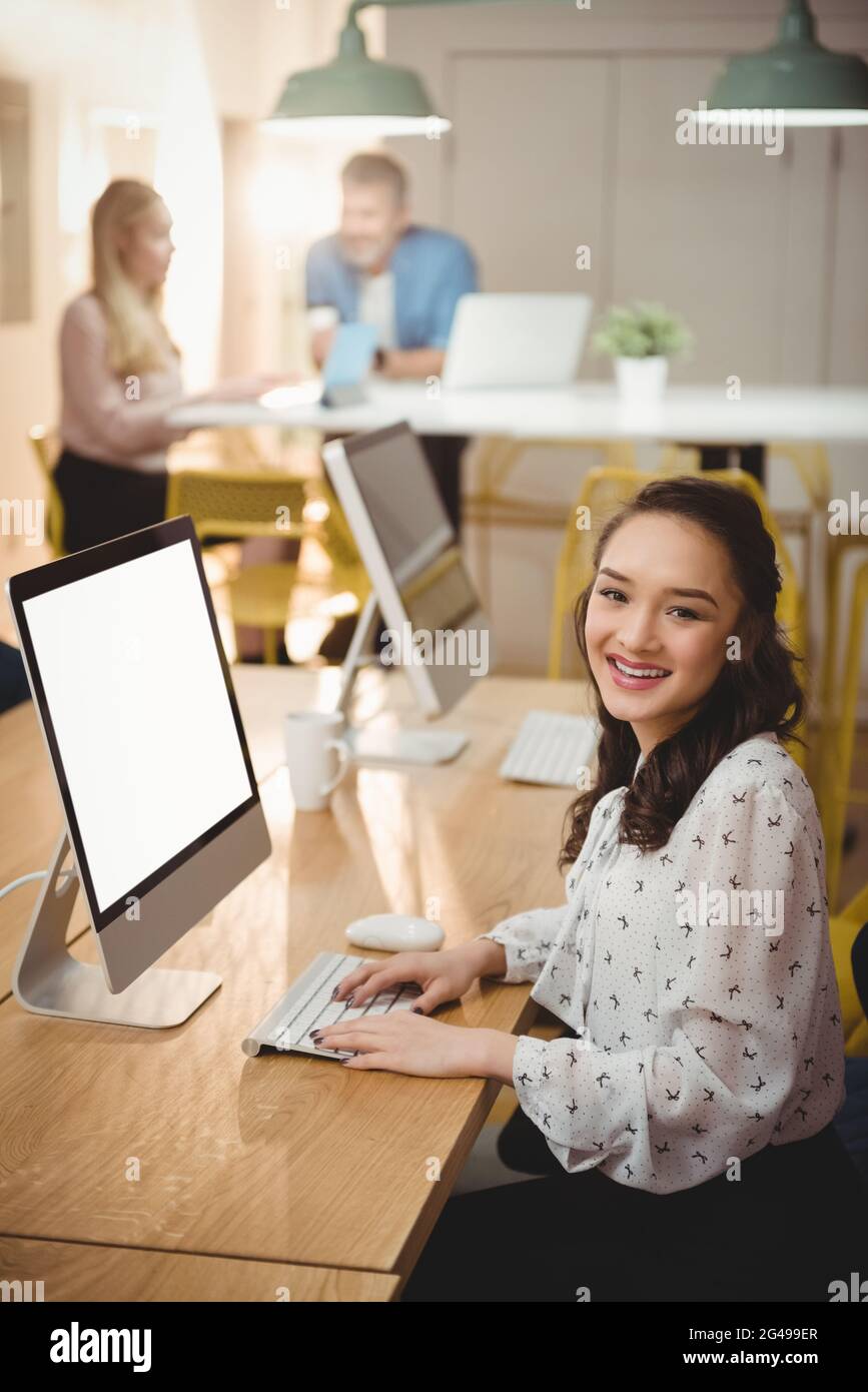 Female executive working on computer in office Stock Photo - Alamy