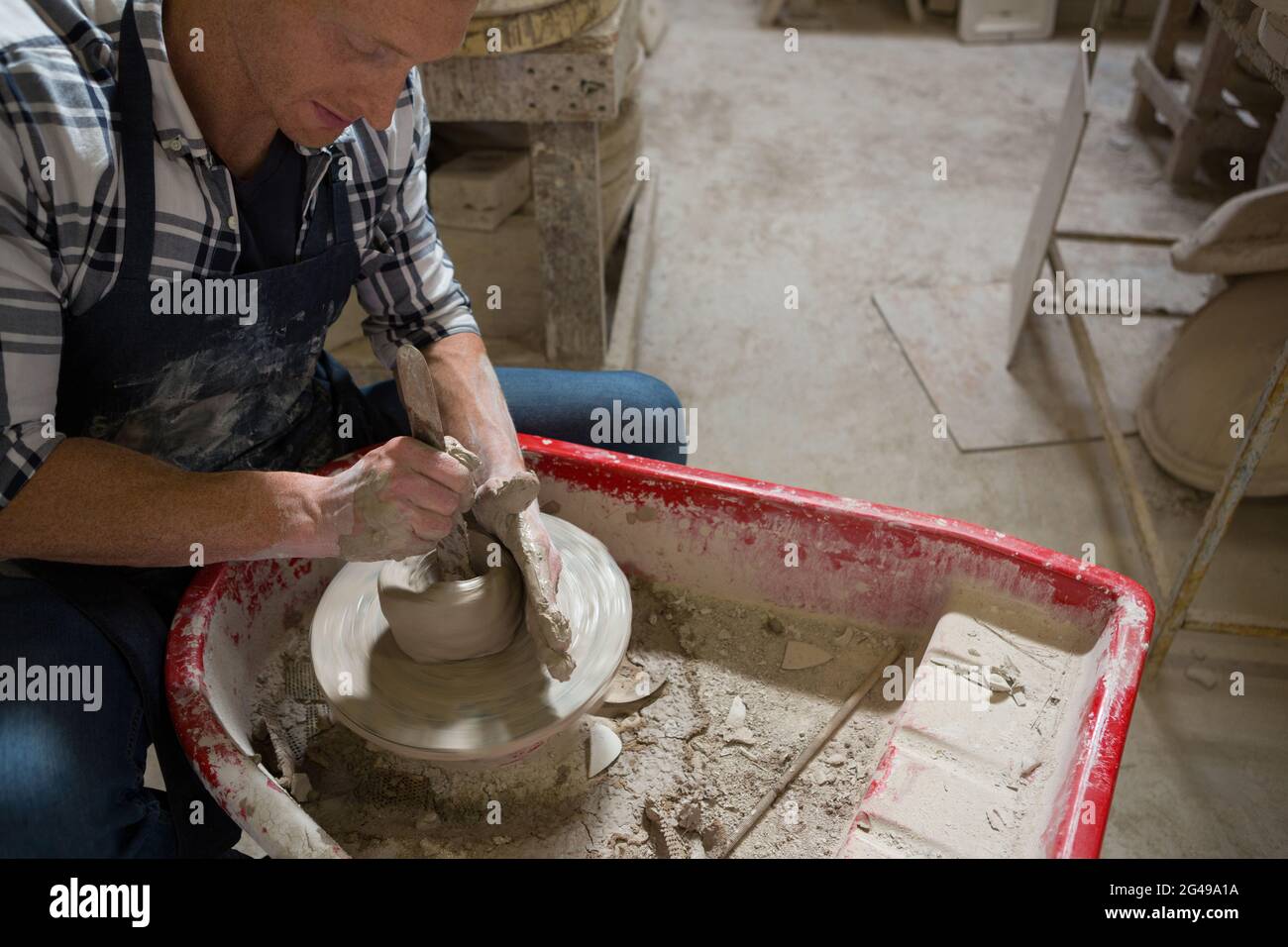 Mid adult man sitting pottery hi-res stock photography and images - Alamy