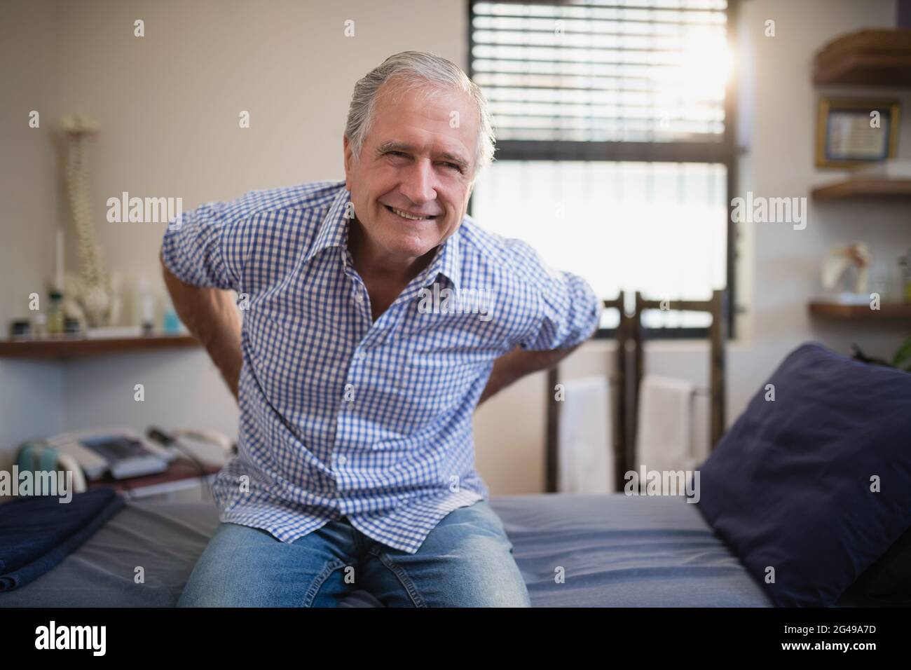 Senior male patient frowning with backache Stock Photo - Alamy