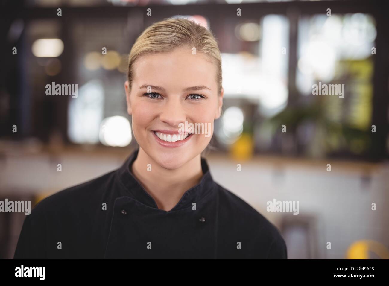 Portrait of smiling attractive waitress Stock Photo - Alamy