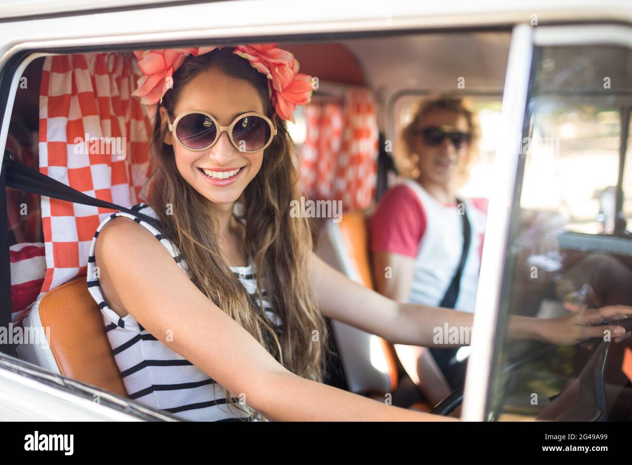 Portrait of smiling woman driving camper van Stock Photo - Alamy