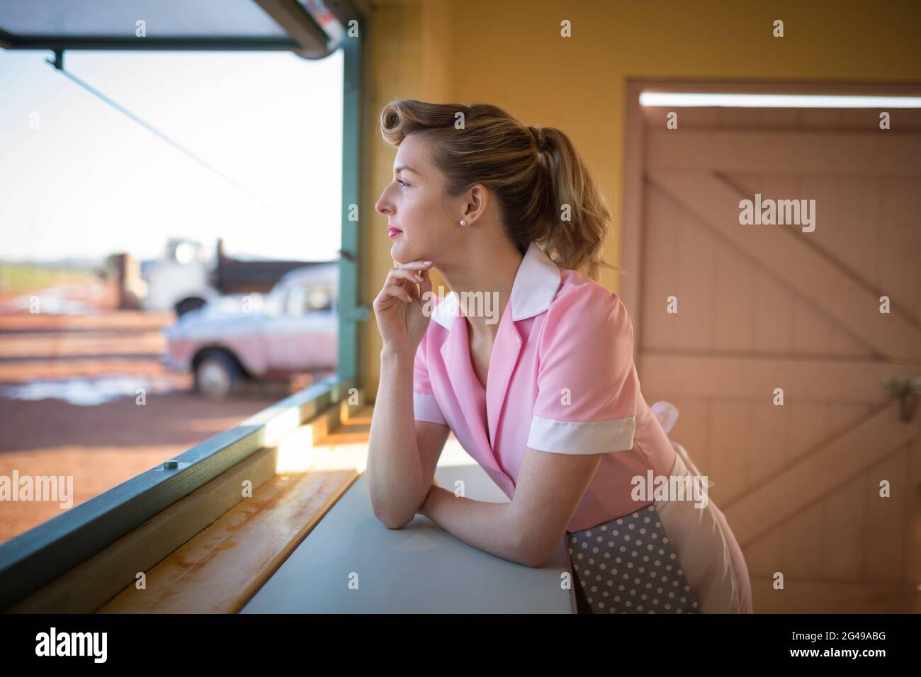 Waitress standing at counter in restaurant Stock Photo - Alamy