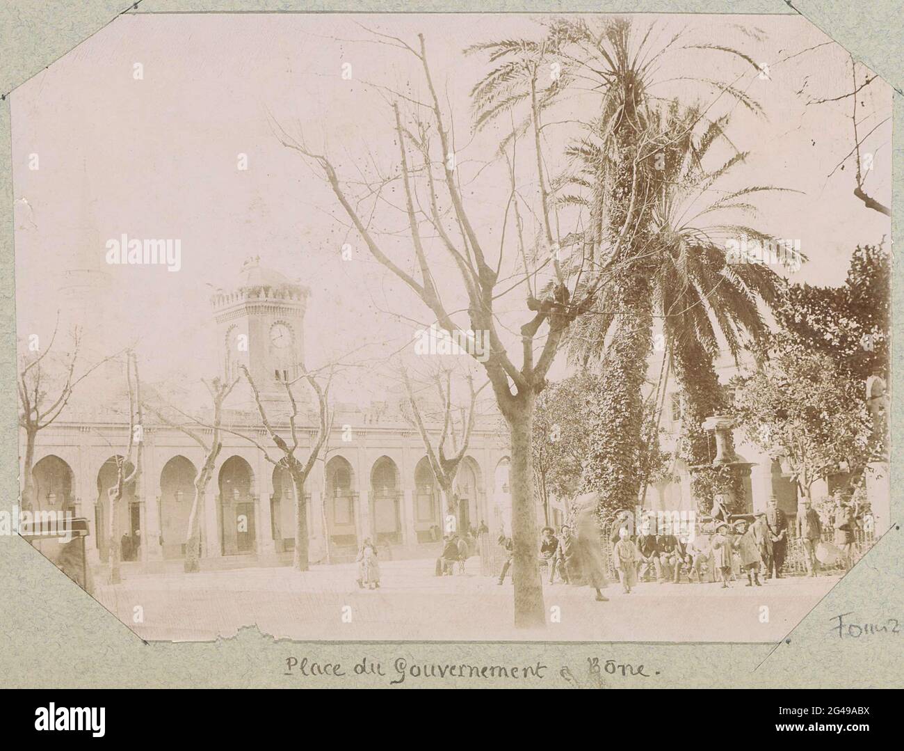 Place du Government in Bône in Algeria with children, buildings and trees. Part of a French ...