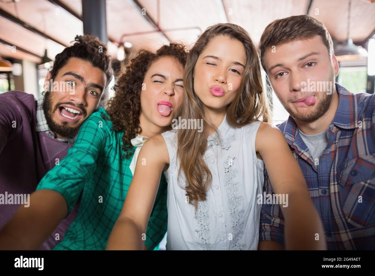 Friends making face in restaurant Stock Photo - Alamy