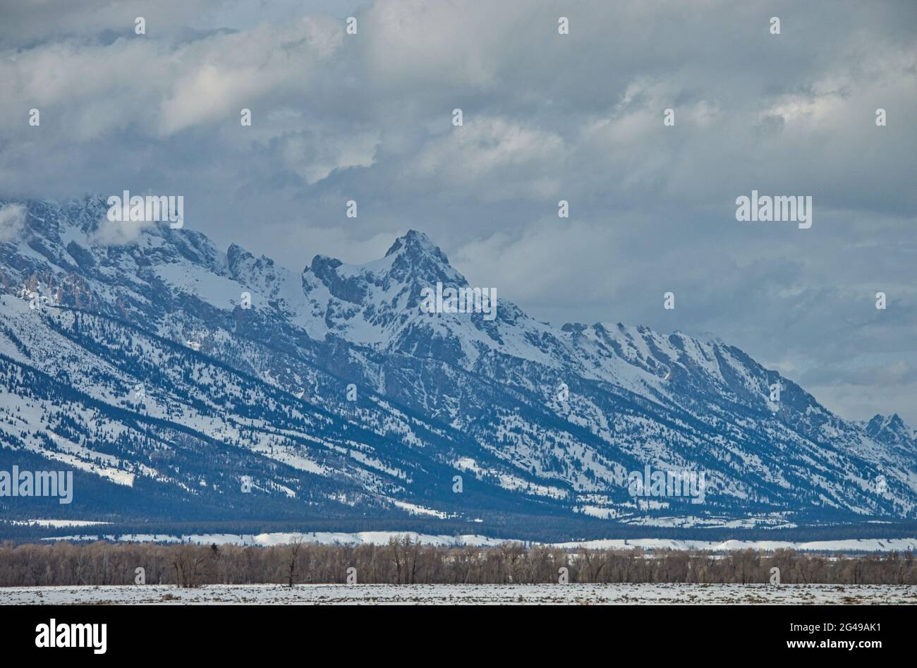 A beautiful shot of a majestic snowy mountain ran on background of the ...
