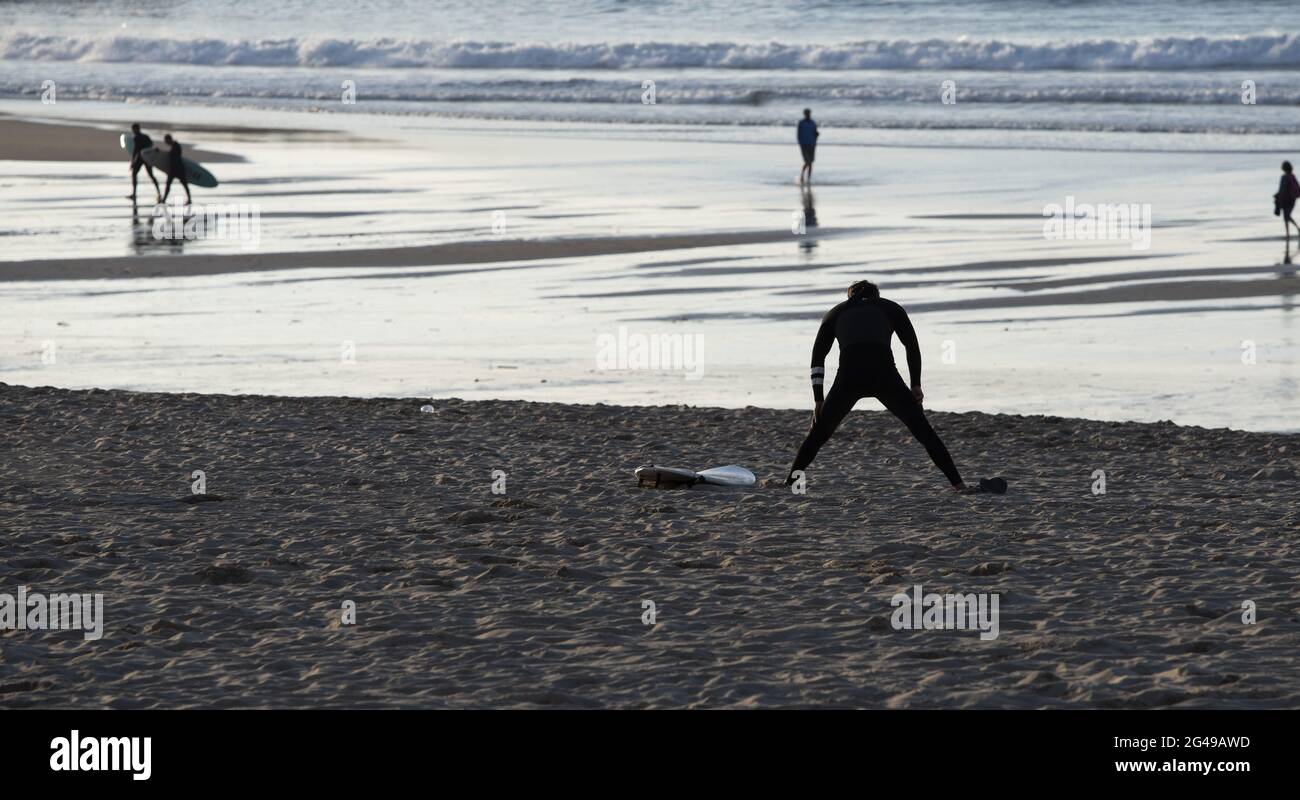 A scenic view of swimmers and surfers on the beach Stock Photo - Alamy