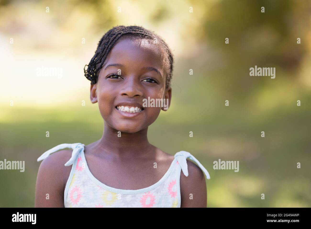 Smiling girl standing in forest Stock Photo - Alamy