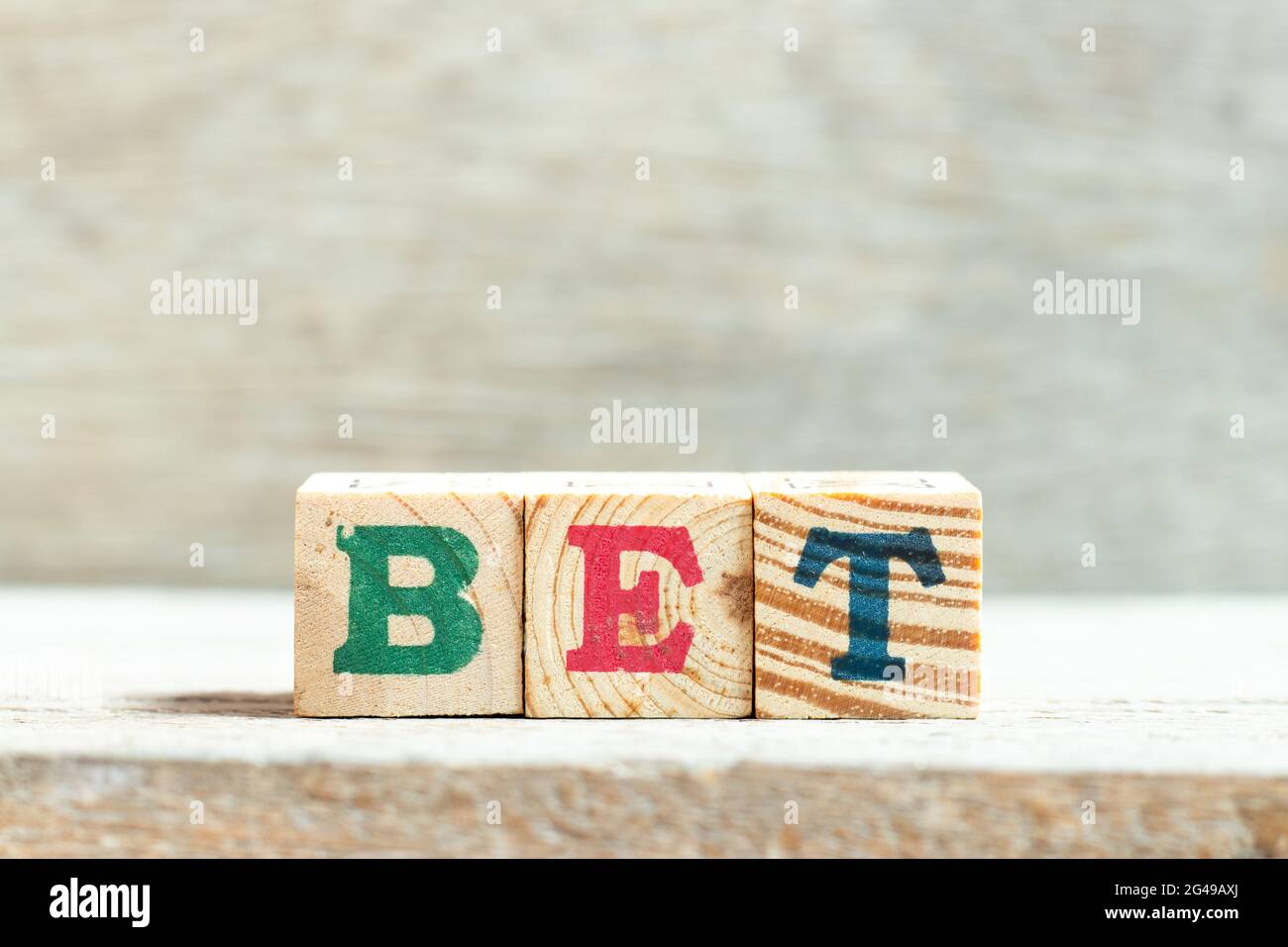Alphabet letter block in word bet on wood background Stock Photo - Alamy