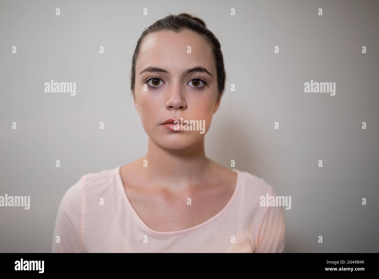 Close-up portrait of young female therapist against wall Stock Photo ...