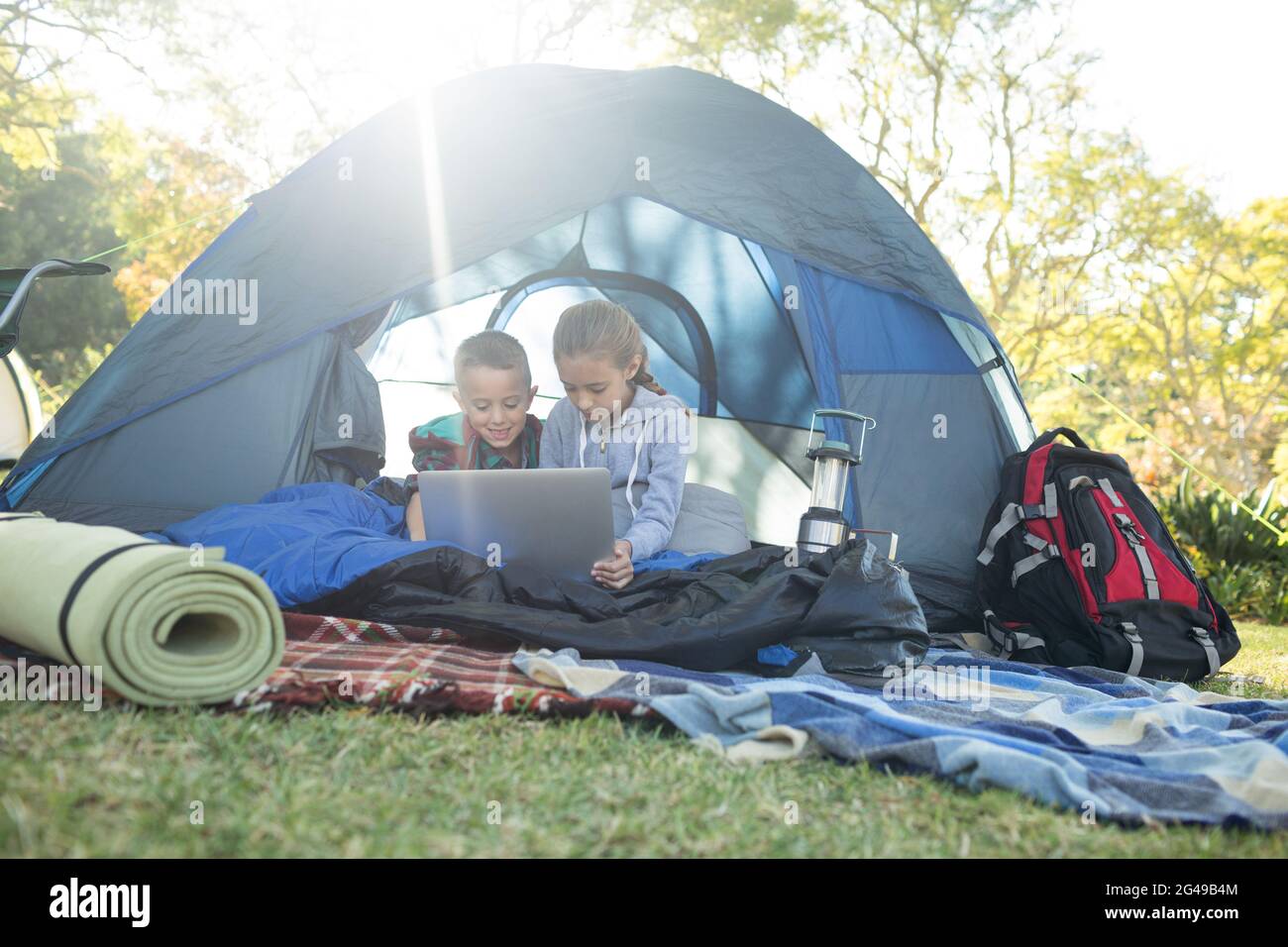 Kids using laptop in the tent Stock Photo - Alamy