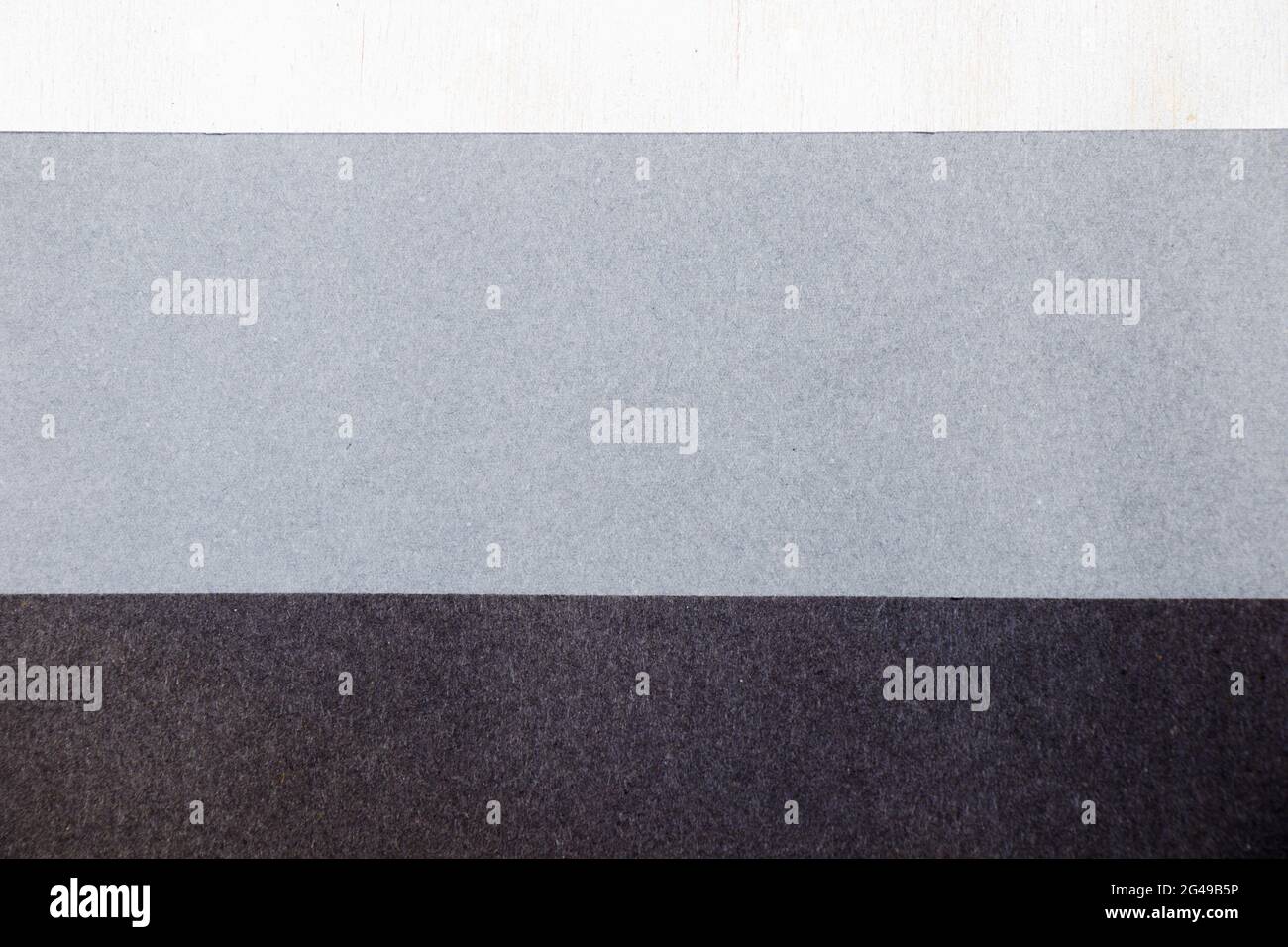 A closeup of gray, black, and white papers background for a copy space ...