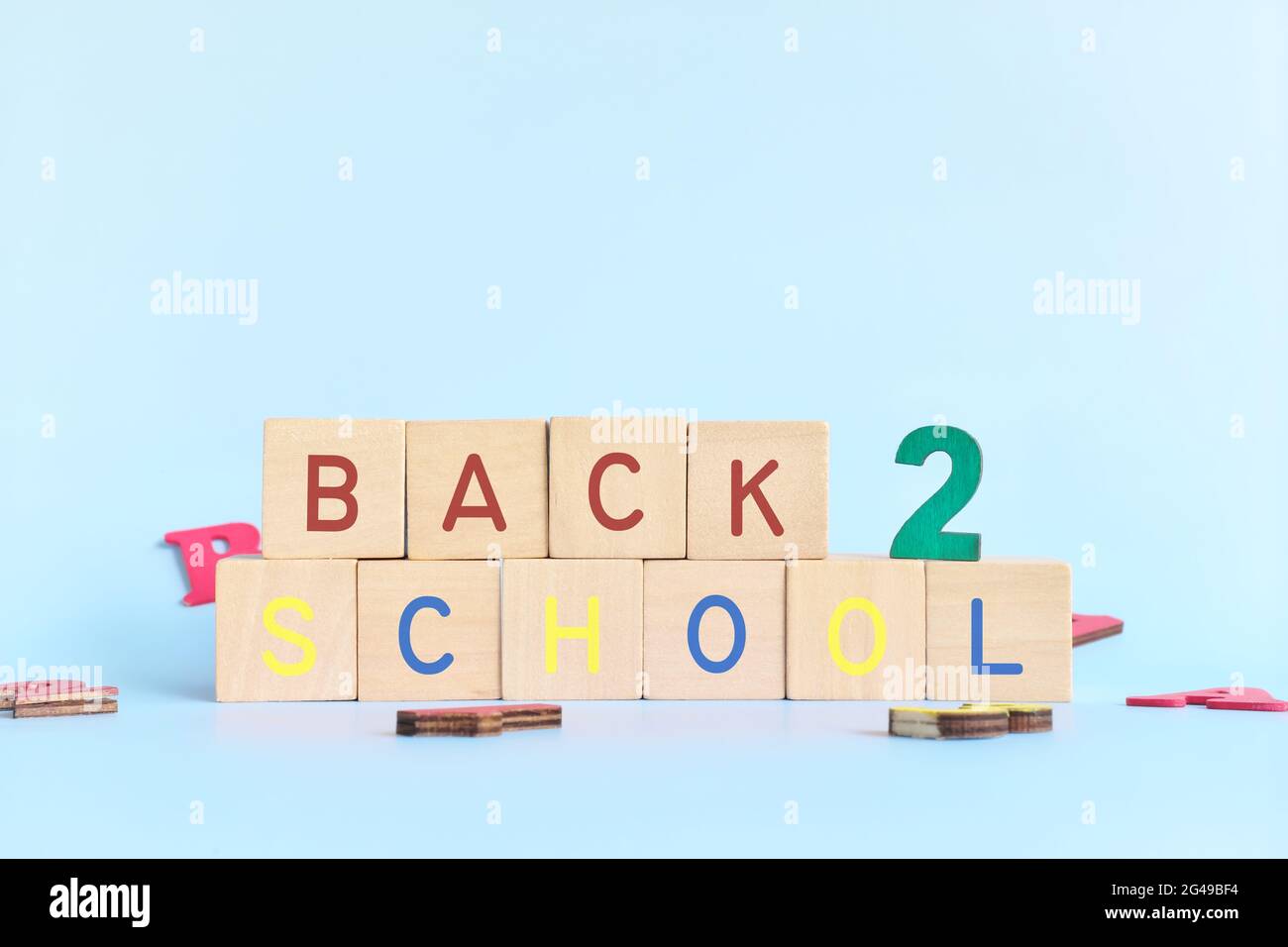 Colorful back to school typography in wooden blocks in blue background ...