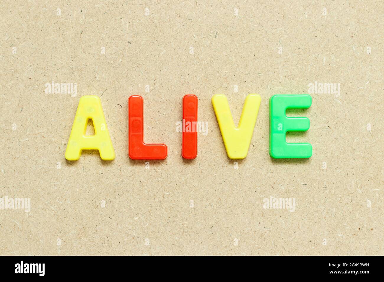 Color alphabet letter with word alive on wood background Stock Photo ...