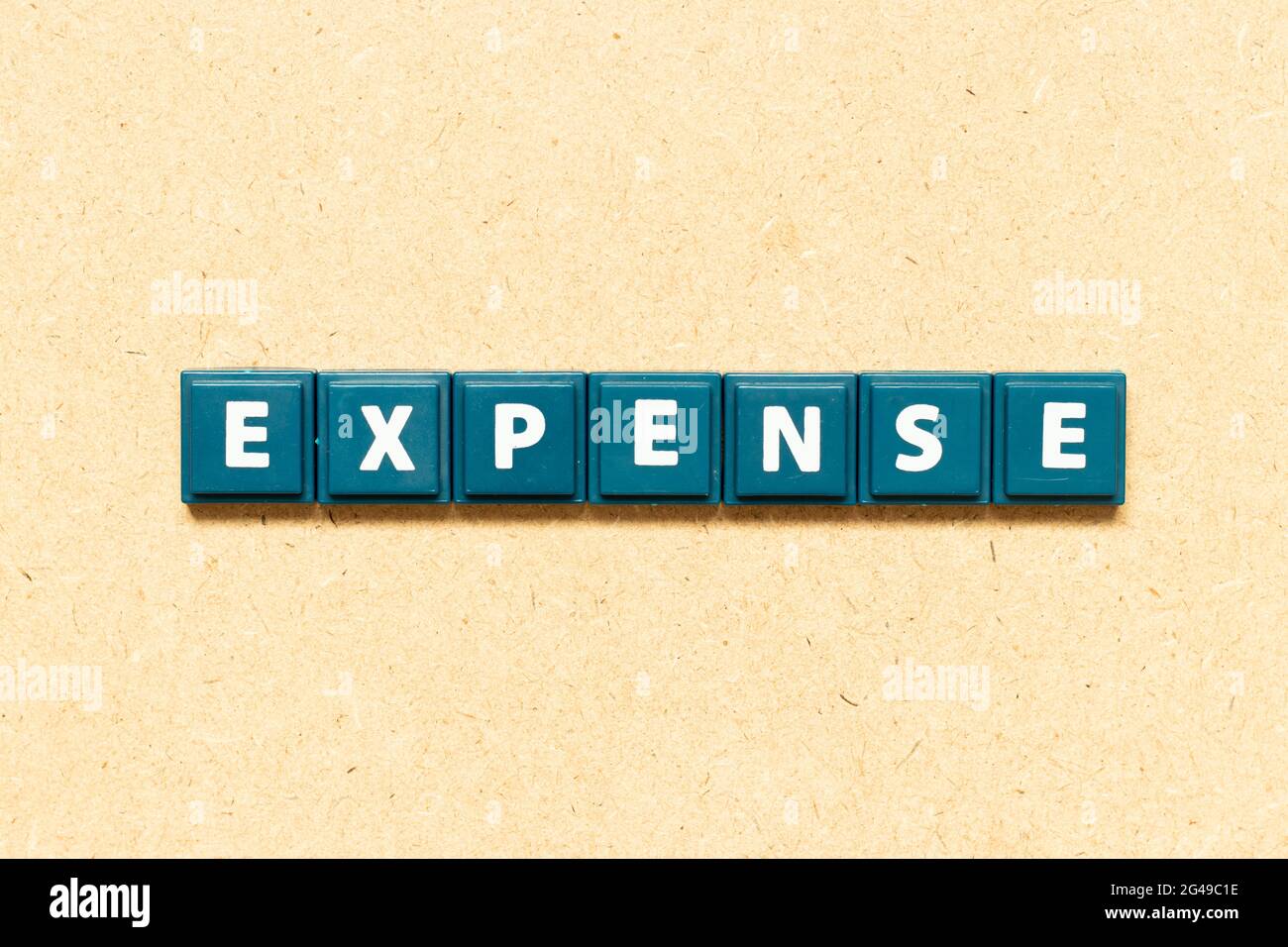 Tile alphabet letter in word expense on wood background Stock Photo - Alamy
