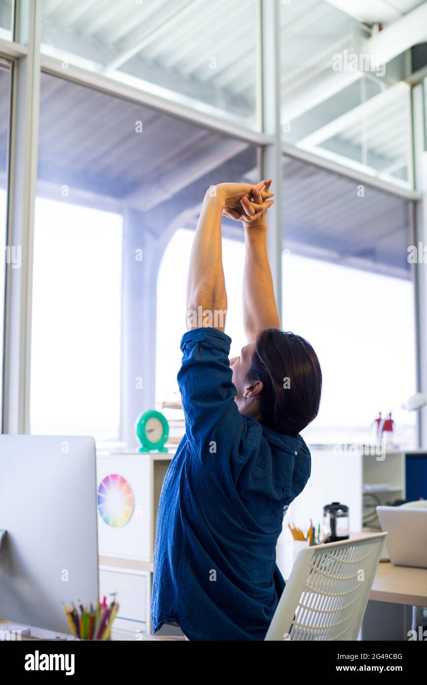Man stretching arms desk hi-res stock photography and images - Alamy