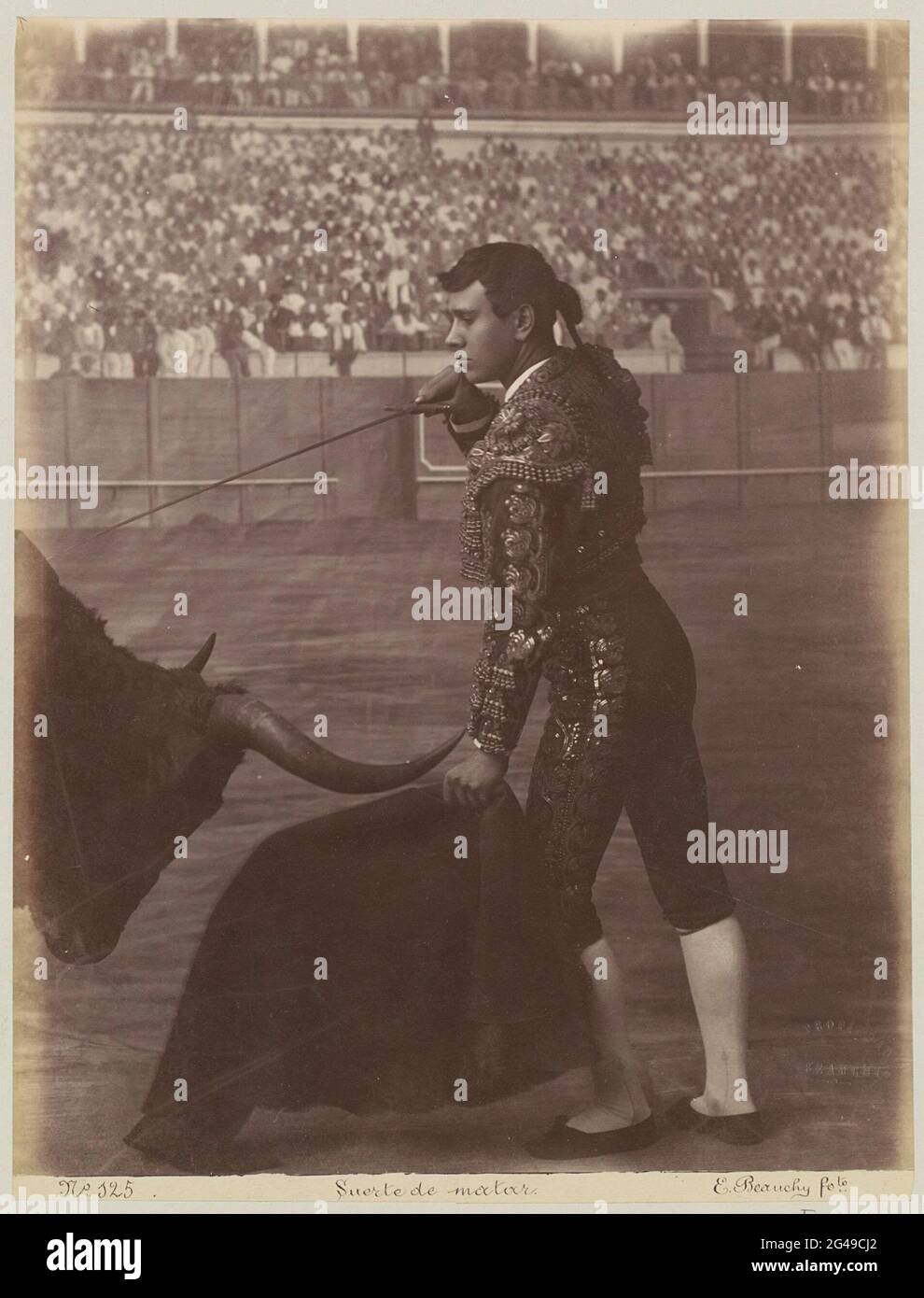 Bullfighter with swords (Matador) and bull in an arena, presumably in ...