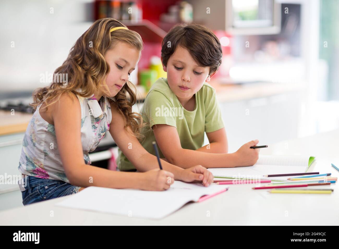 Happy siblings studying together hi-res stock photography and images ...