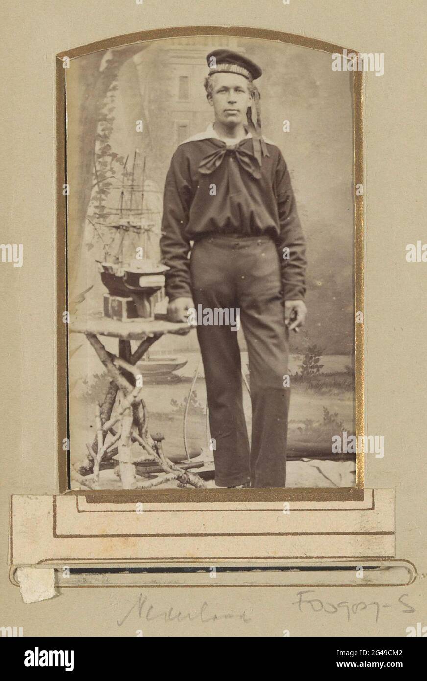 Portrait of a sailor of the royal navy, standing at a ship model on the ...