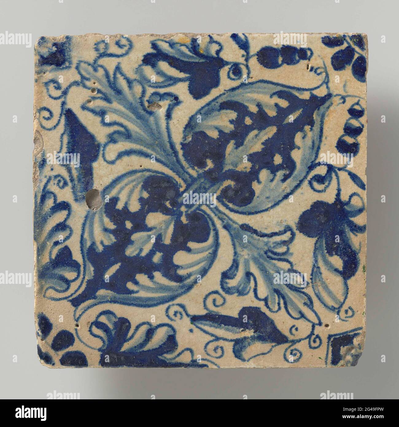 Tile. Tile with blue painted leaf patterns of oak leaf, placed ...